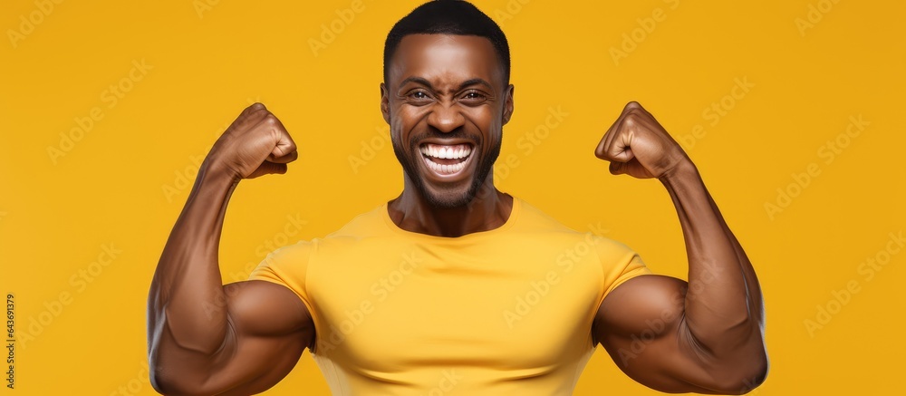 Black man expressing joy and strength showing muscles and gesturing yes ...