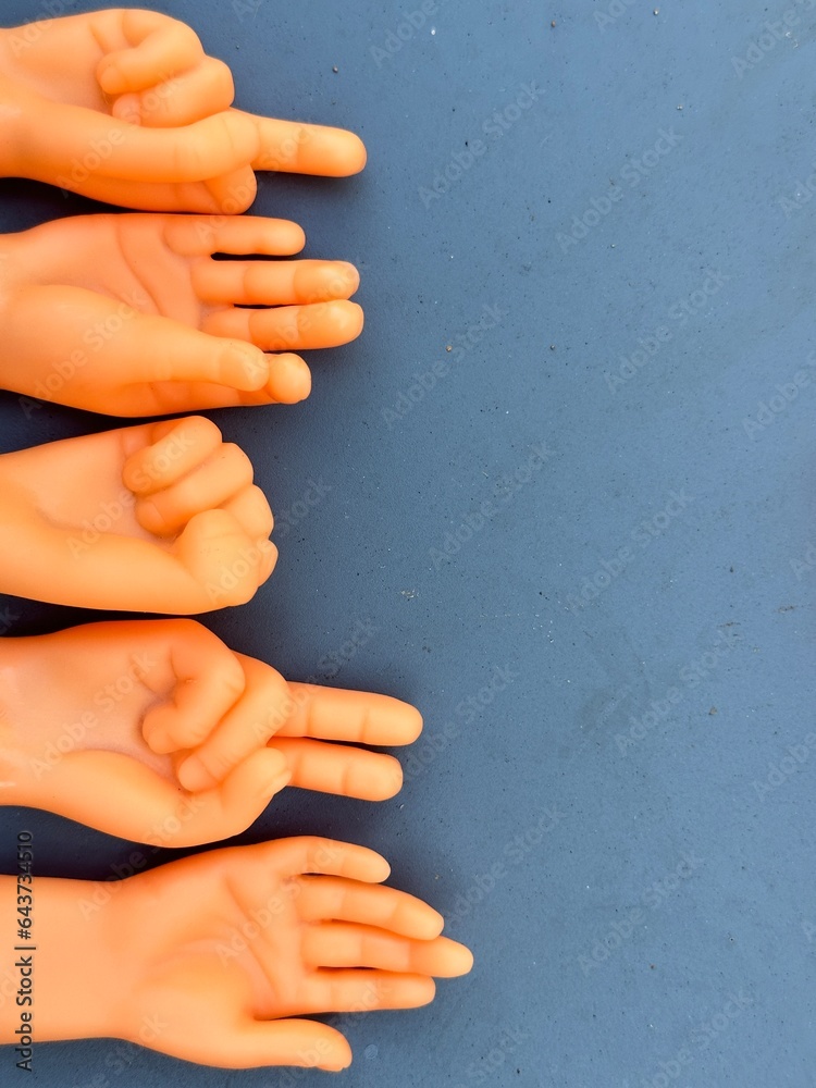 Finger puppets tiny hands showing various gestures on grey background ...