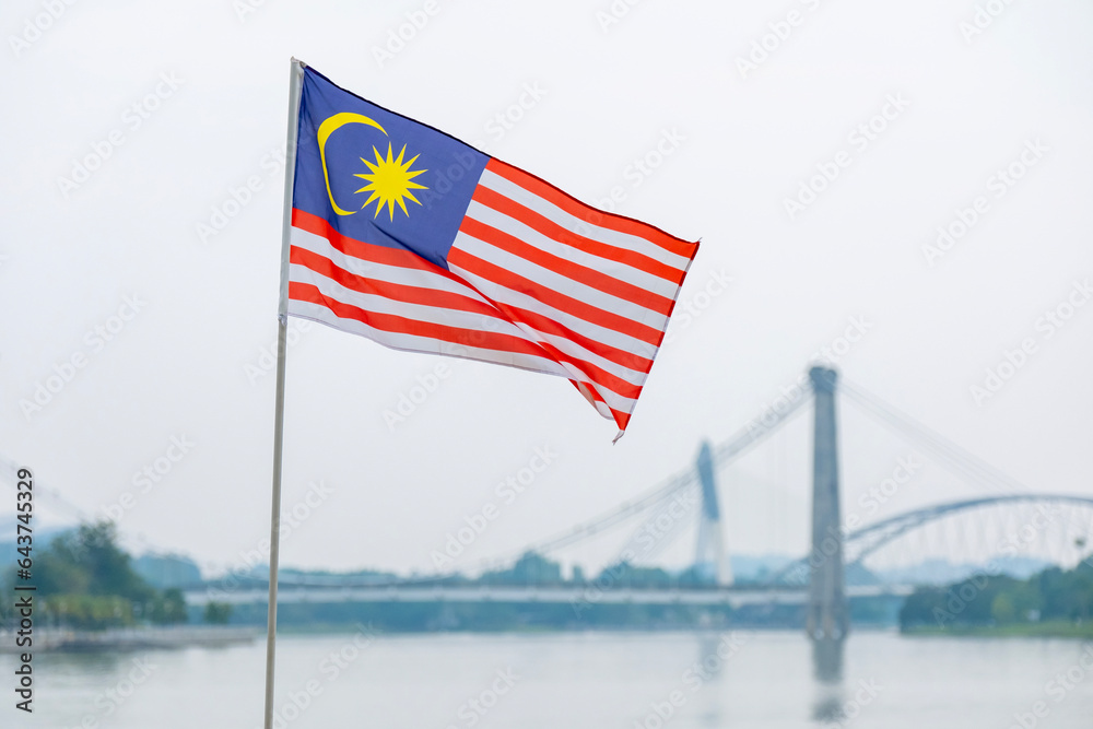 The Malaysia flag is also known as Jalur Gemilang waving with a city in ...