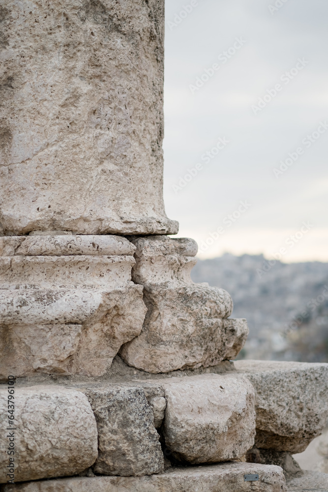 At the base of a monumental marble column, architectural details are ...