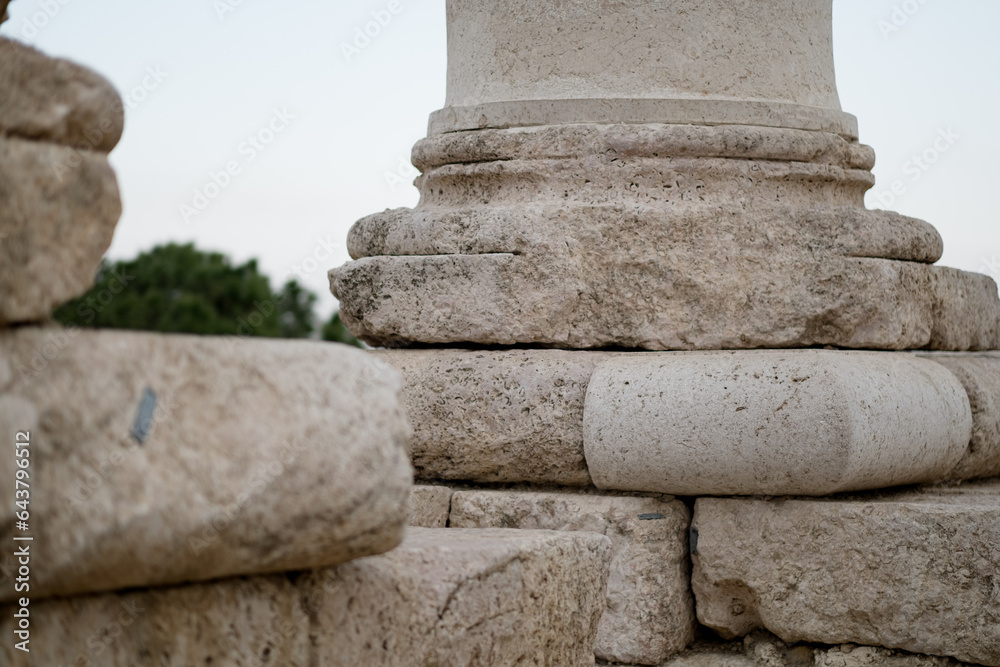 At the base of a monumental marble column, architectural details are ...