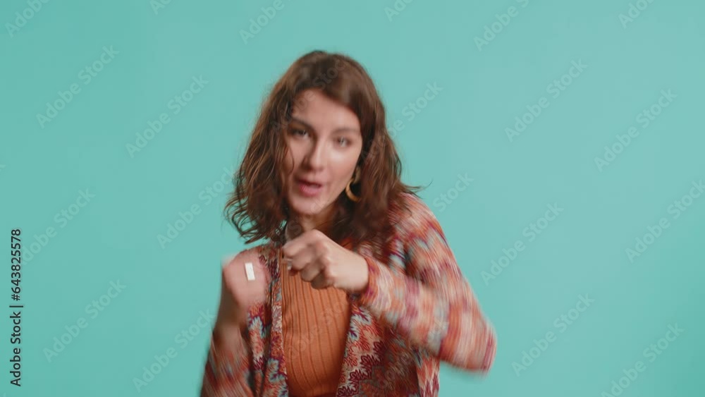 Aggressive angry young woman trying to fight at camera, shaking fist ...