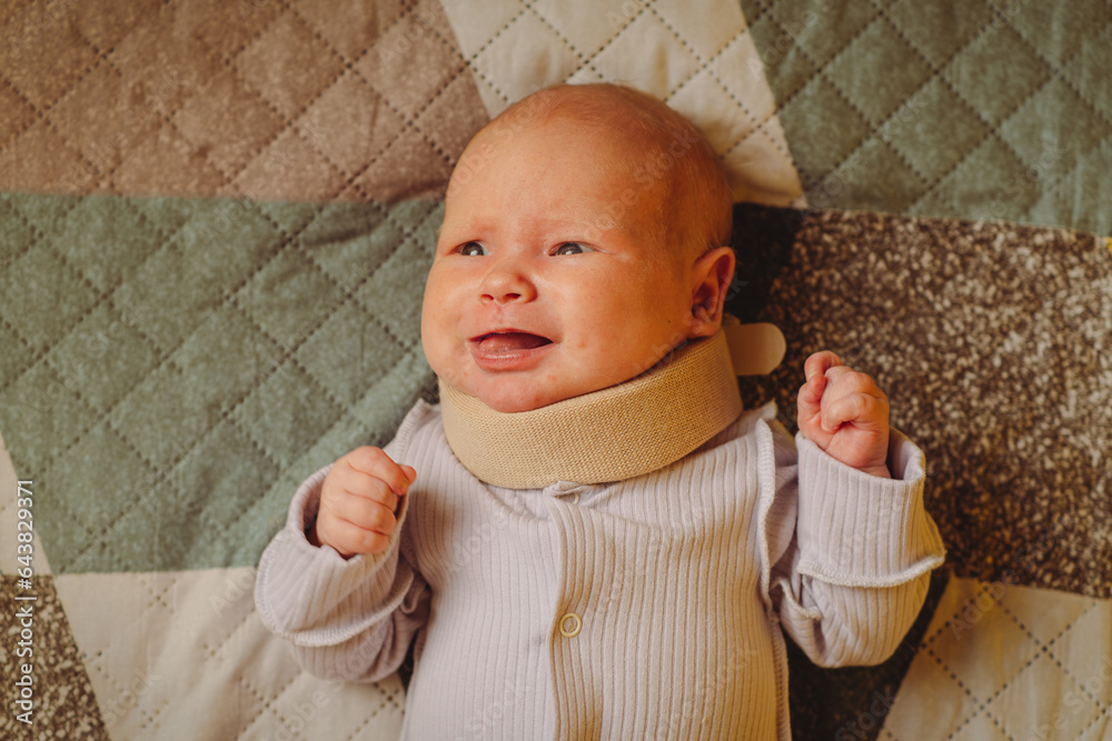 Cute newborn baby in a neck brace. Kid wearing cervical collar ...