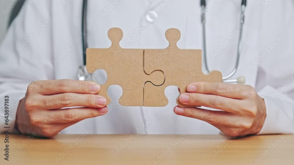 Doctor hand connecting couple puzzle piece, wooden jigsaw in hospital ...
