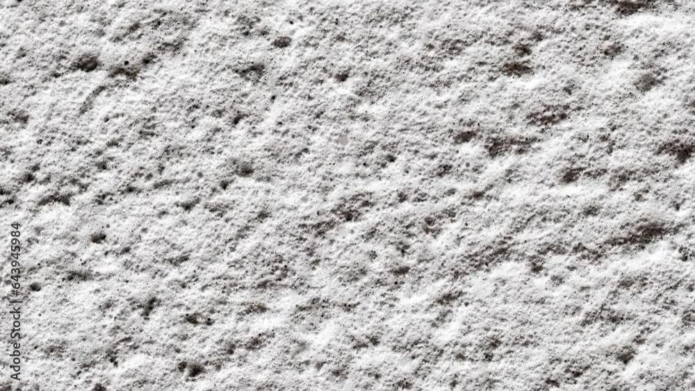 Plastered rough grey wall with lumps, rotating, turning, close-up macro ...