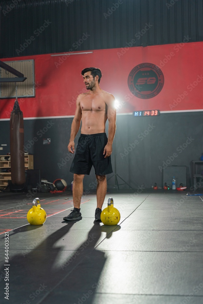 Handsome and muscular Middle Eastern man lifts heavy dumbbells ...