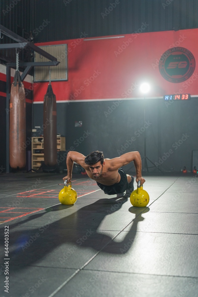 Handsome and muscular Middle Eastern man lifts heavy dumbbells ...