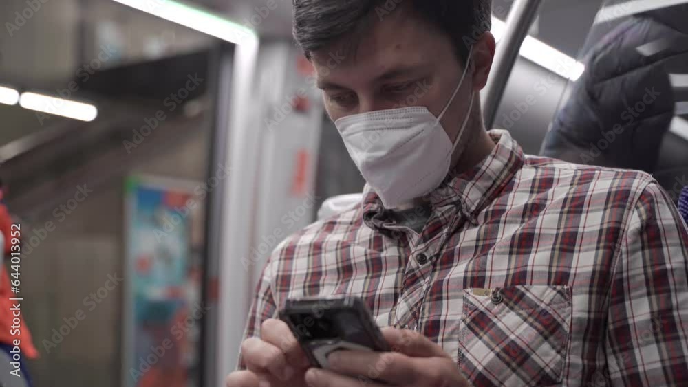 Masked passenger on subway in Munich uses 5G Internet on his smartphone ...
