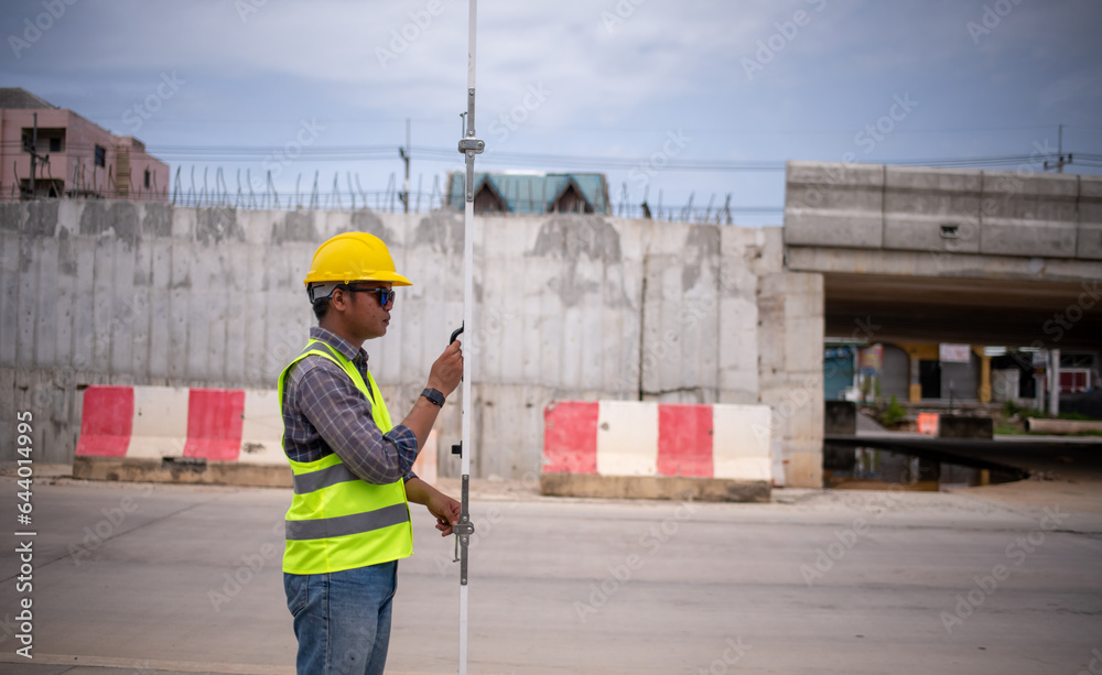 Engineers Surveyor wearing safety uniform ,helmet with equipment ...