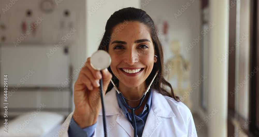 Close up head shot portrait smiling Latina female cardiologist in ...