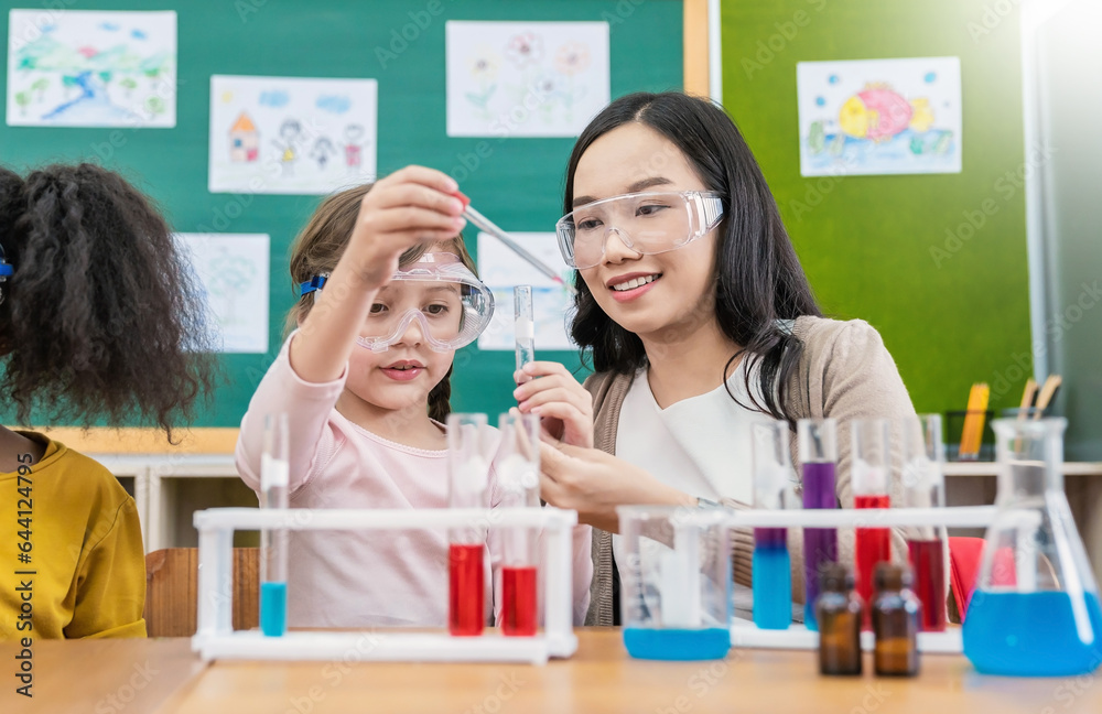 close up hands of little children playing blocks in classroom. Learning ...