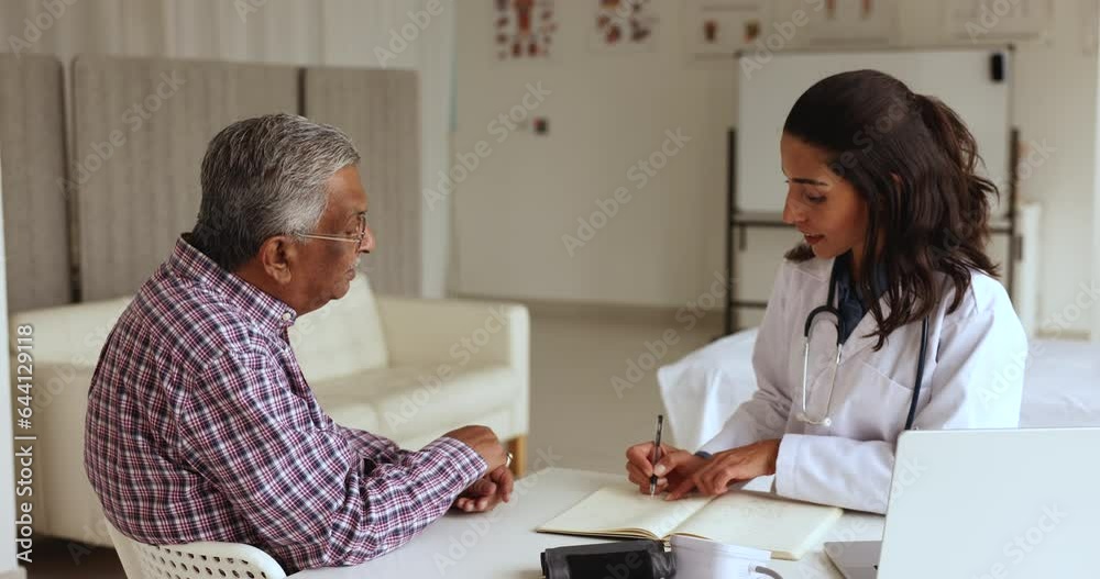 Young 35s female professional doctor consulting old male patient ...