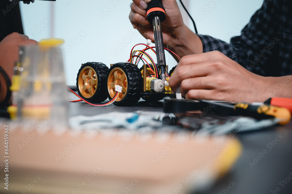 Foto de Engineer Asian Students Assembling Robotics Kits. Learning ...
