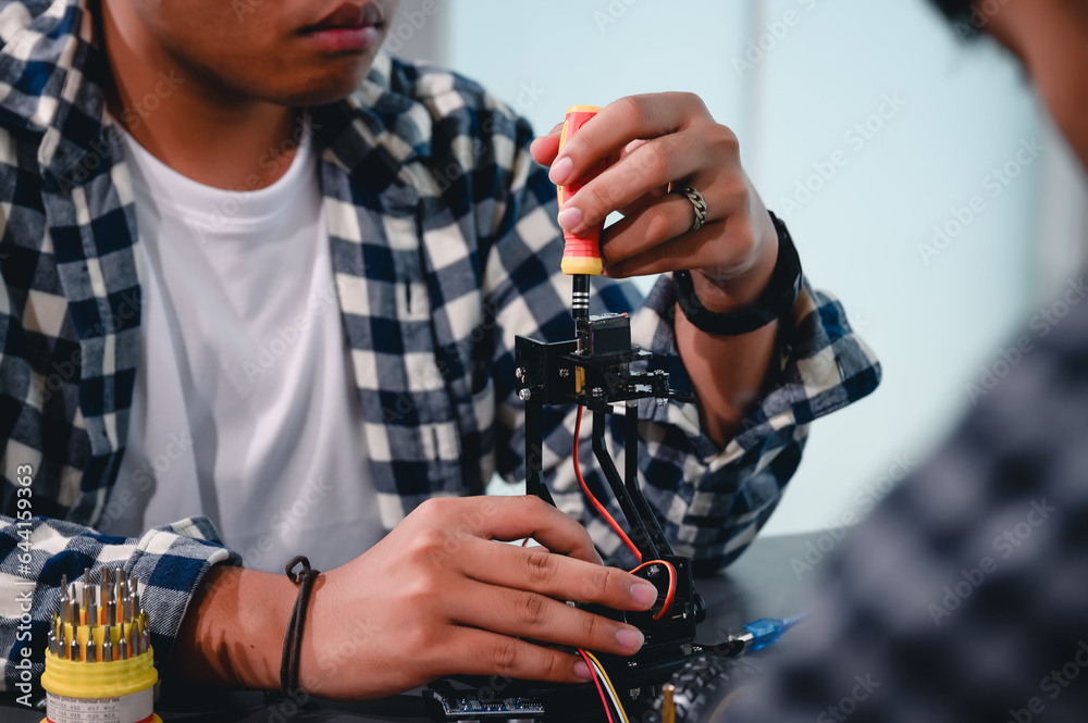 Engineer Asian Students Assembling Robotics Kits. Learning Mechanical ...