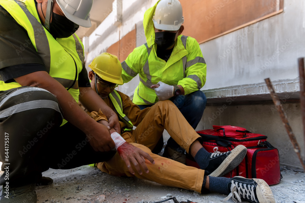 First aid team support to builder worker after hand injury bleeding ...