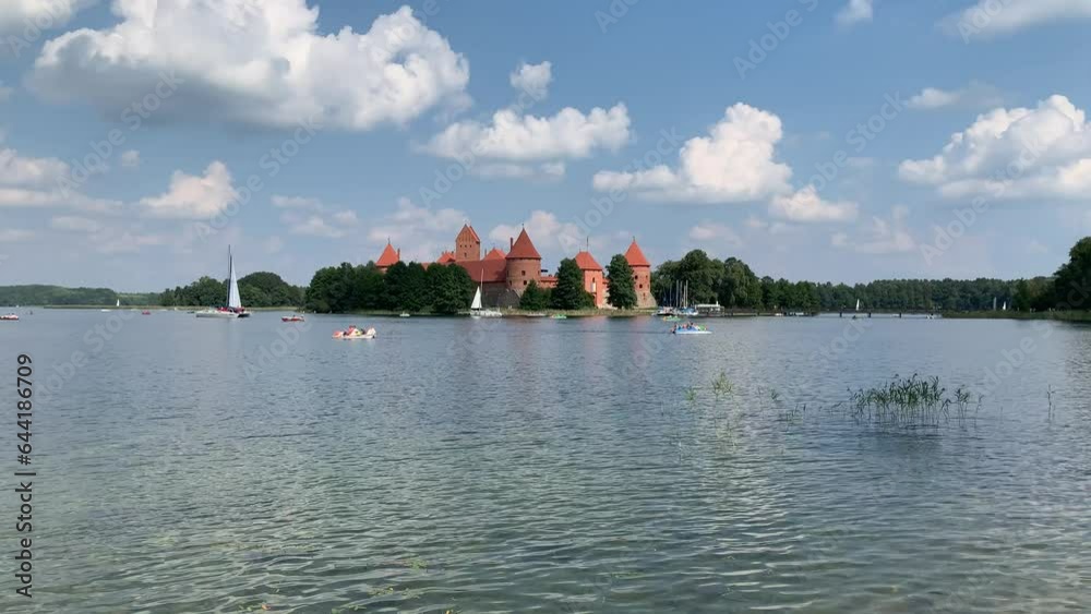Trakai Island Castle surrounded by green trees. Historical red brick ...