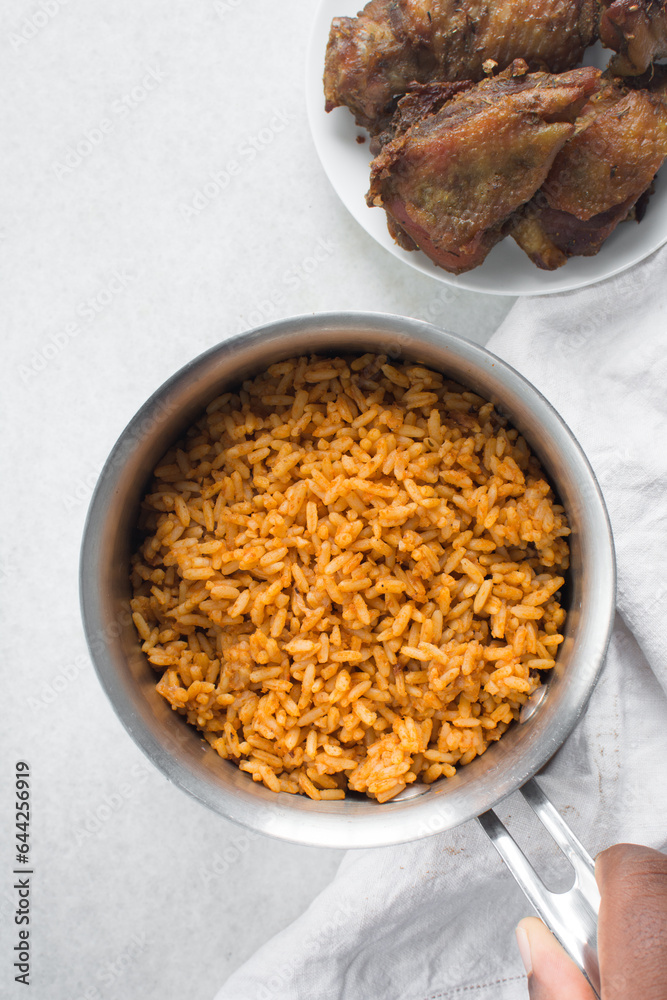 Jollof rice in a silver saucepan, homemade nigerian jollof rice in a ...