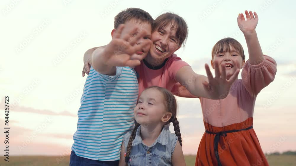 Mom, Children happily wave their hands, look at camera. Happy child ...