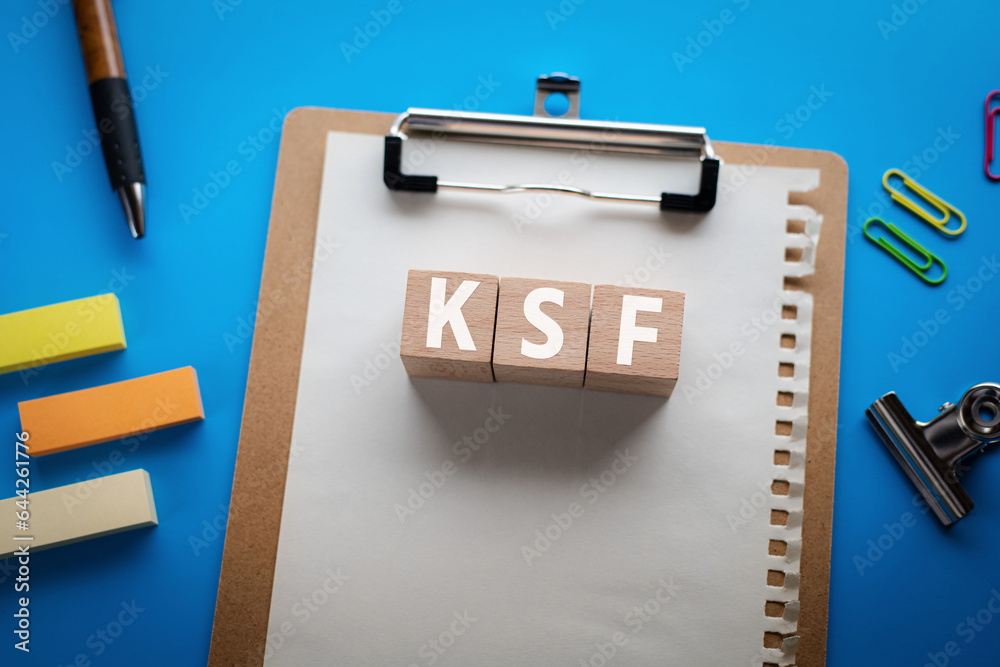 There is wood cube with the word KSF. It is an abbreviation for Key ...