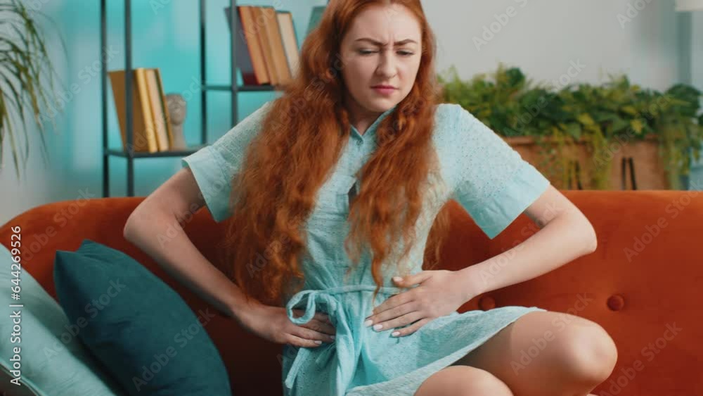 Sick ill redhead woman suffering from period cramps, painful stomach ...