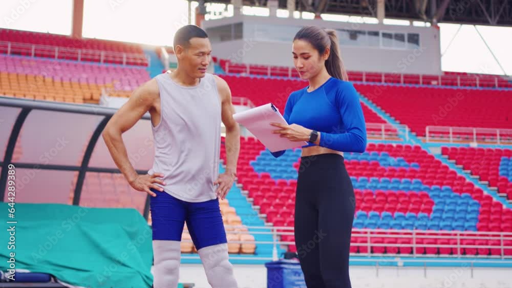 Asian athlete with prosthetic blades and trainer workout in stadium ...