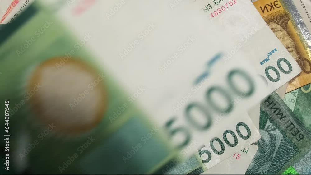 Counting five thousand dollar bills placed on table. New 5000 Kyrgyz ...