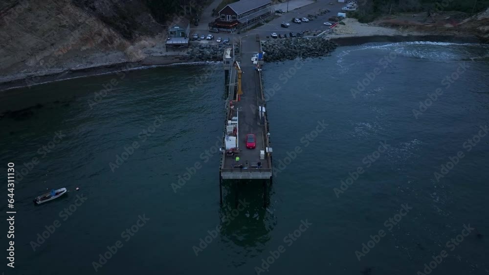 Aerial northern California Point Arena fishing pier late evening. Bay ...
