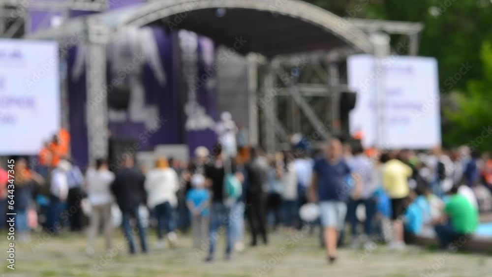 Blurred background. Performance on stage. Crowd of people standing near ...