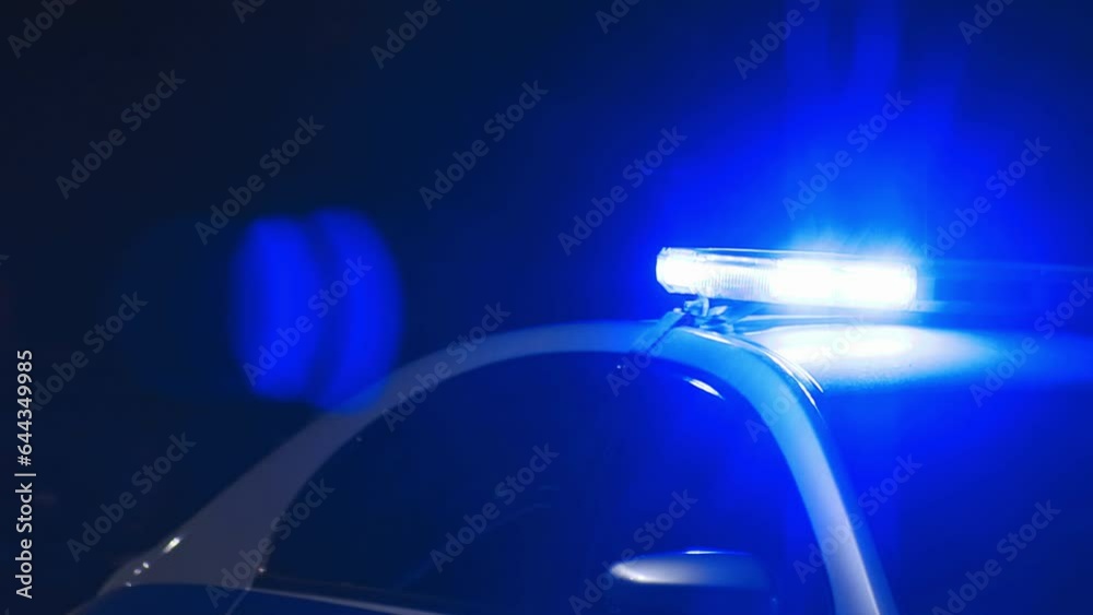 Working blue light flasher lightbar on police car at night, siren ...