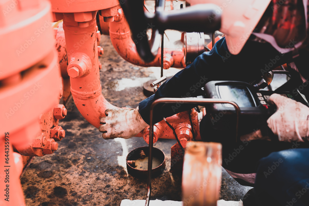 Non-destructive testing technicians are checking the thickness of elbow ...