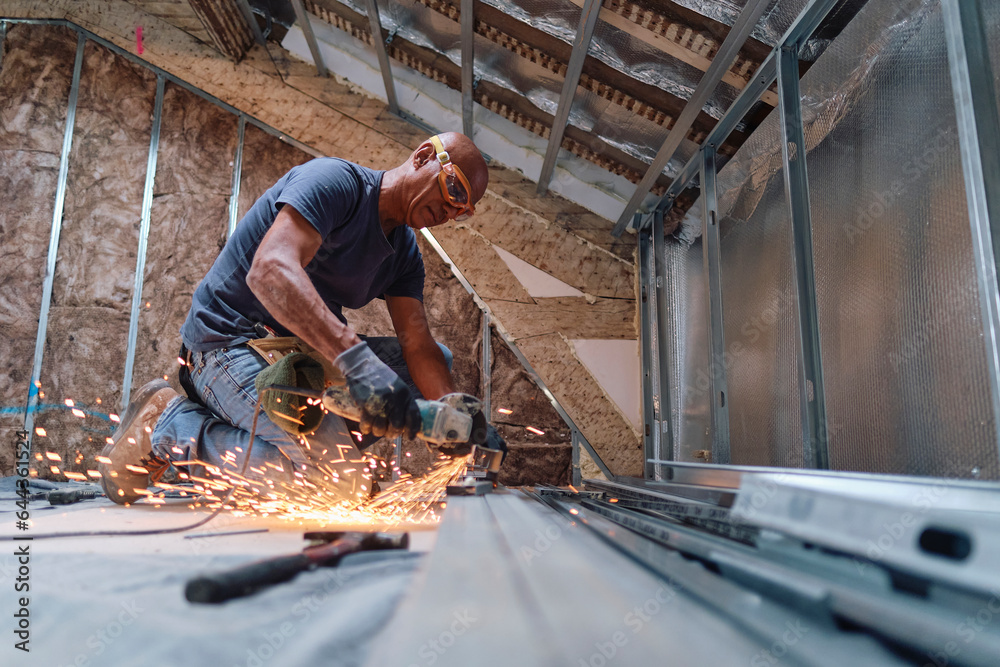 Mature construction worker cutting metal with circular hand saw Stock ...