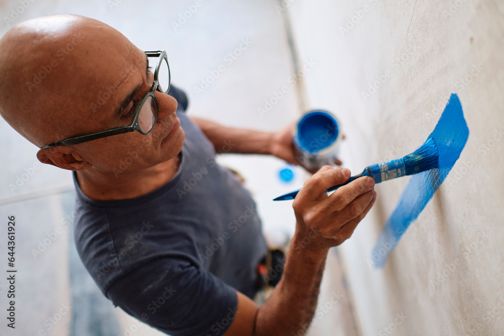 Construction worker painting wall with brush at site Stock Photo ...