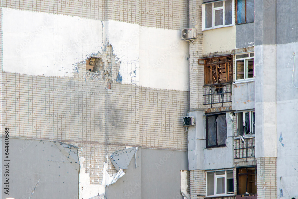 Destroyed apartments in the house after being hit by a downed rocket. shattered windows. A multi ...