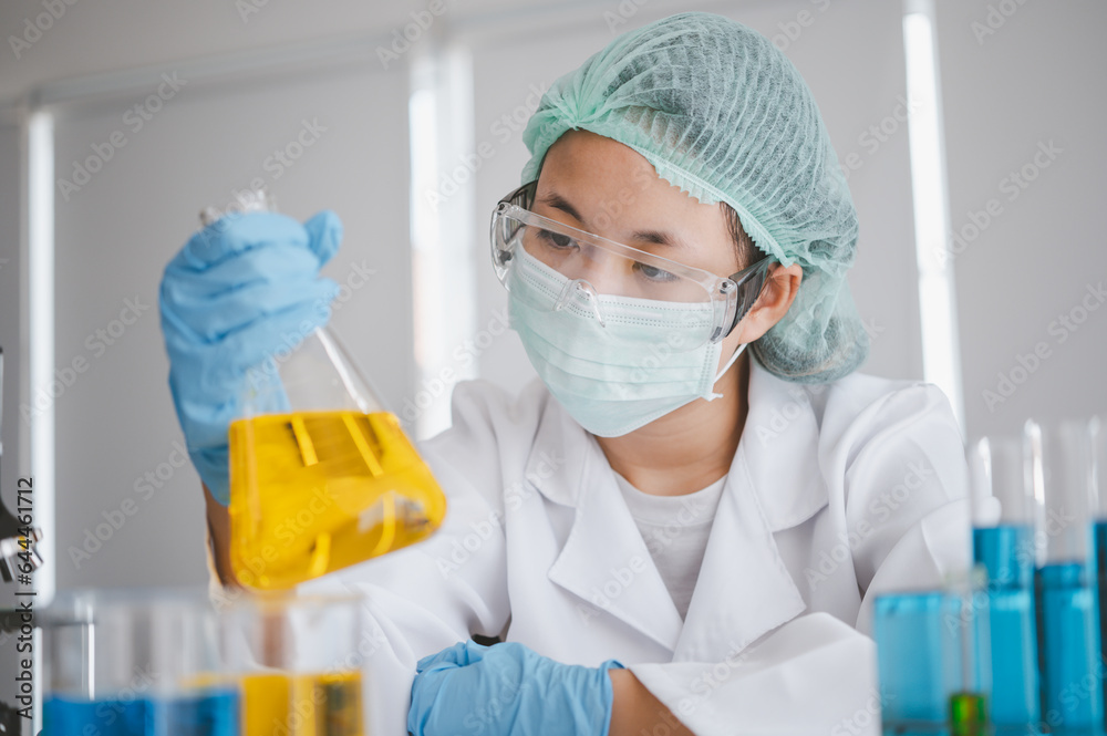 Female researchers are experimenting with pipette dropping a sample ...
