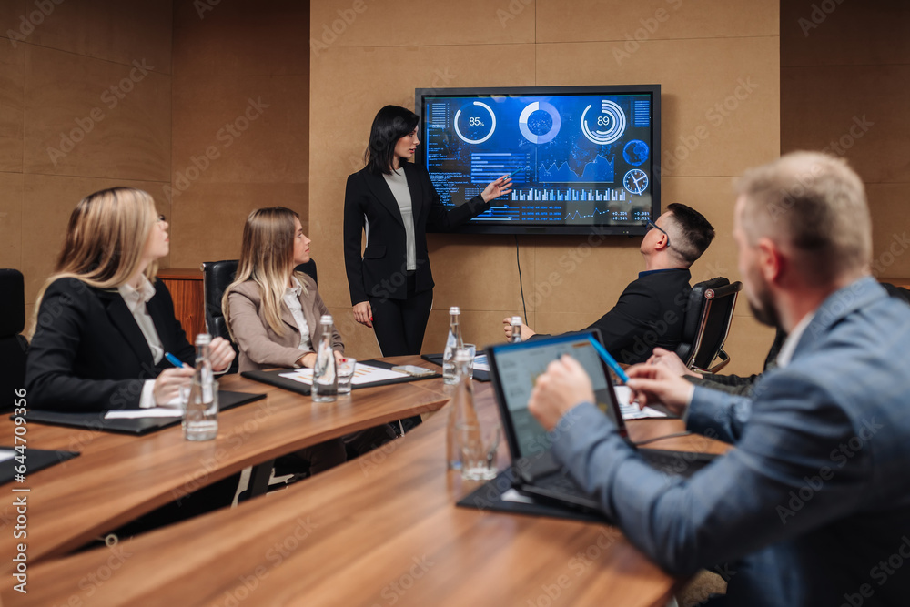 Business meeting in the conference room. A businesswoman is talking to ...