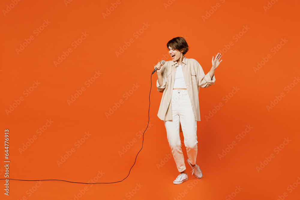 Full body young singer happy caucasian woman she wearing beige shirt ...