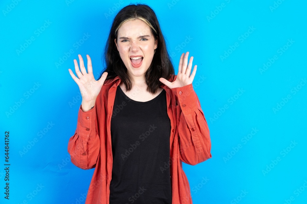 Crazy outraged MODEL screams loudly and gestures angrily yells ...