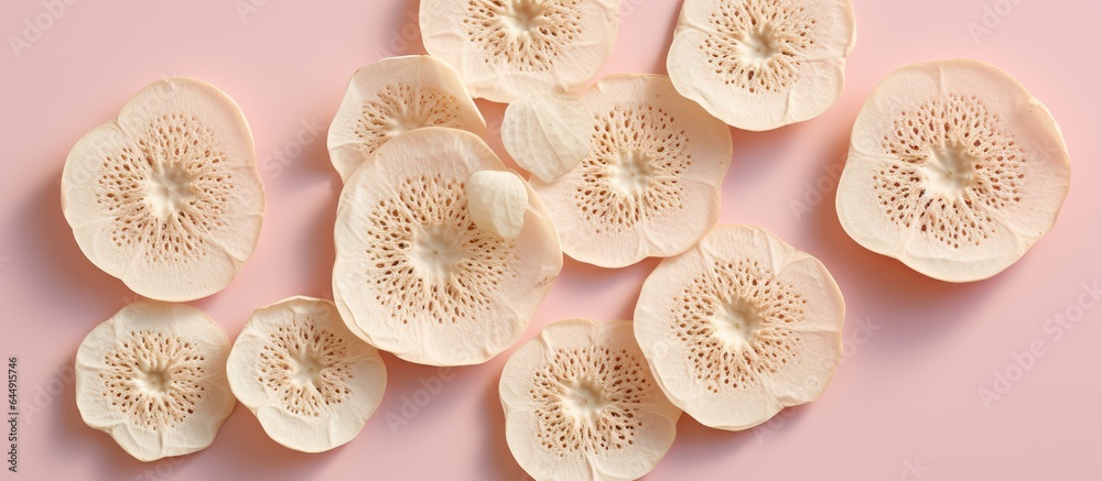Lotus root slices coated in sugar placed on a isolated pastel ...