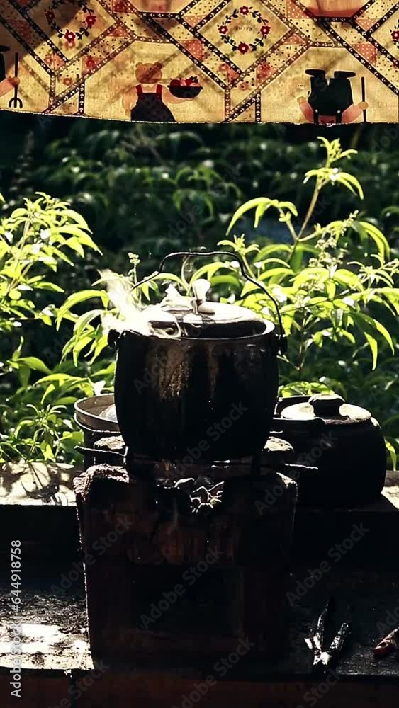 A steaming pot of rice cooking in the old abuhan or a traditional ...