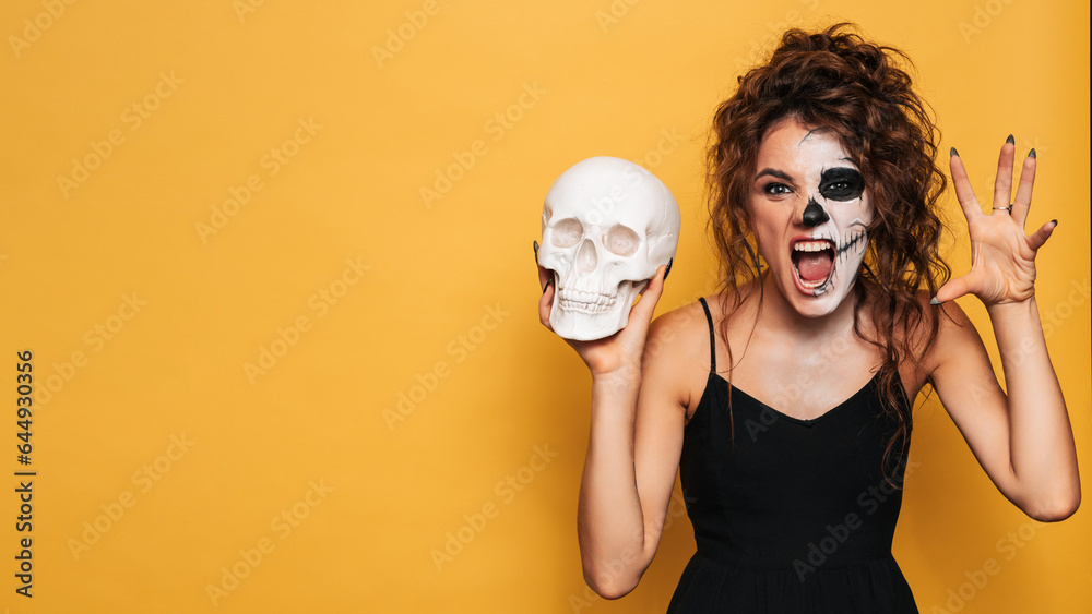 A young woman in a Halloween costume with makeup for the holiday on a ...
