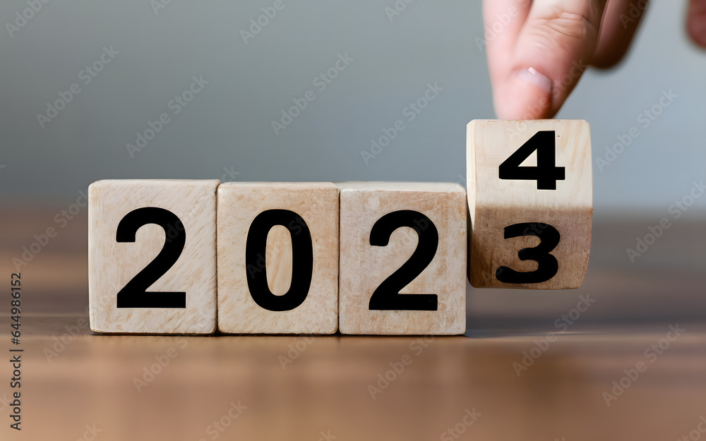 Cube turns from 2023 to 2024 on wooden table. Happy new year 2024 Merry ...
