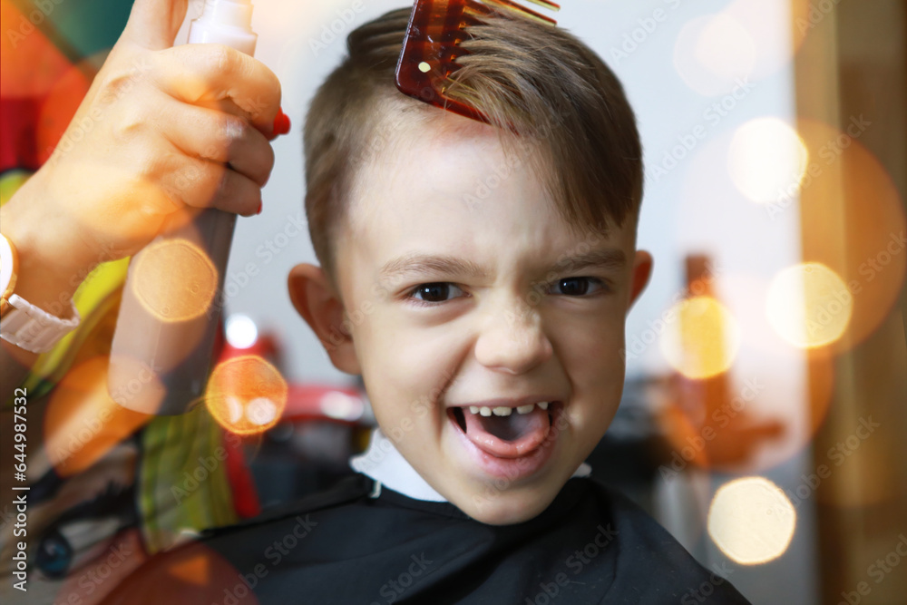 cute boy in the barber shop laughs and makes faces Stock Photo | Adobe ...