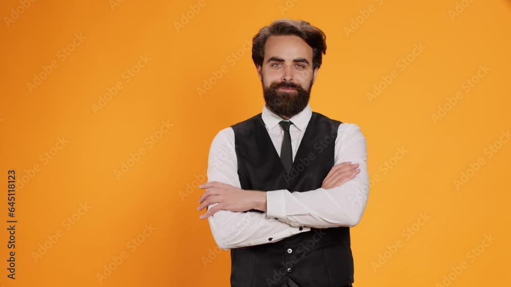 Before serving meal, elegant waiter poses with reliability in front of ...