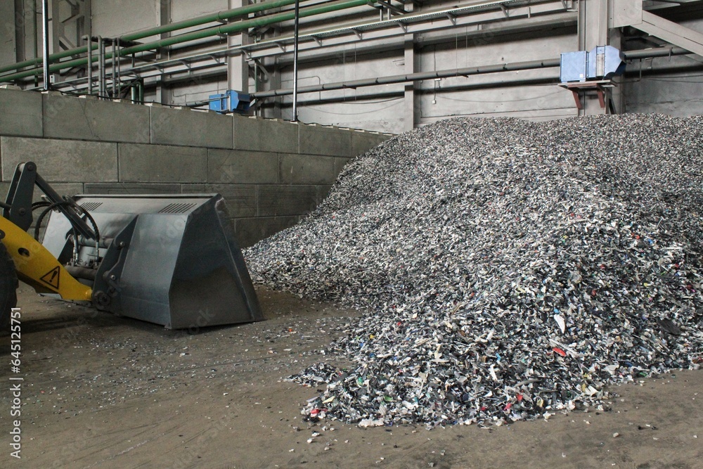 Shredded plastic pieces prepare for recycling. Raw cables material for reproduction. Sorting ...