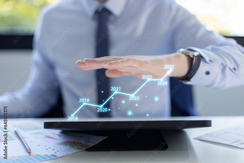 Target growth to year 2025 concept. Businessman using tablet with graph ...