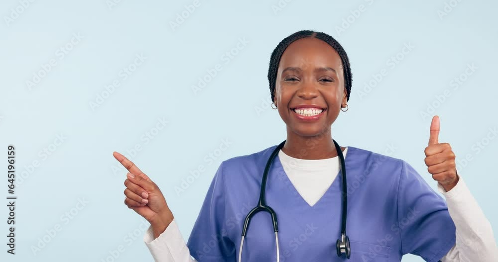Happy black woman, doctor and pointing with thumbs up in success against a studio background ...