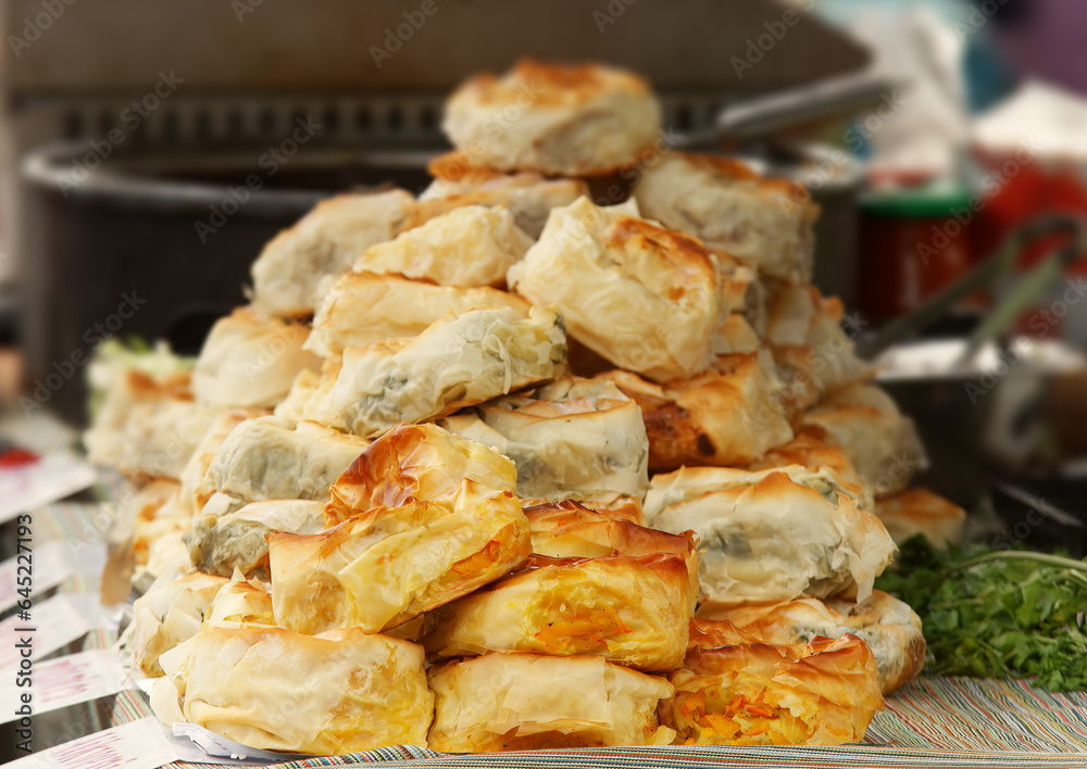 Burek, savoury stuffed phyllo rolls, a Balkan speciality, on display at ...