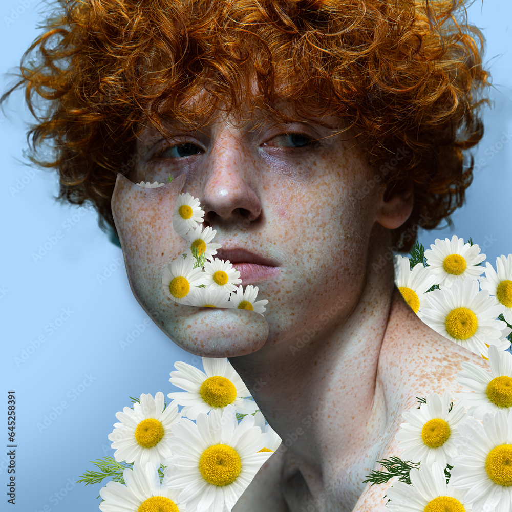 Handsome redhead guy with freckles and chamomiles flowers around face ...