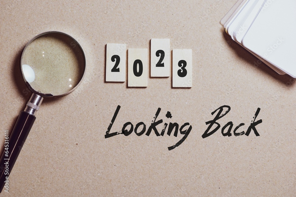 The inscrption 2023 looking back on brown background on desk. The year ...