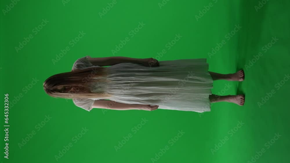 Full-size vertical green screen, chroma key video of a posessed female ...